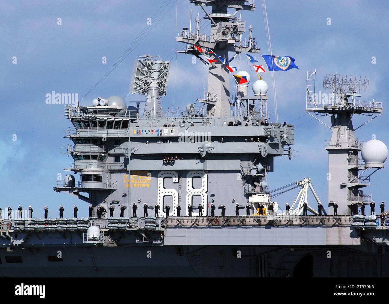 US Navy Sailors man the rails on the flight deck aboard the nuclear ...