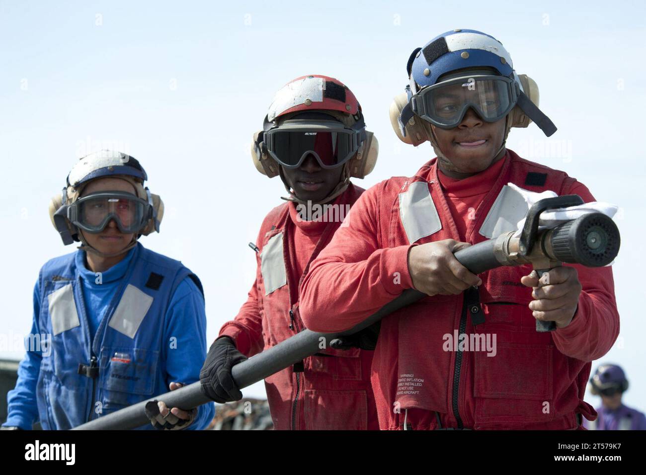US Navy Sailors participate in a flight deck fire fighting drill aboard ...