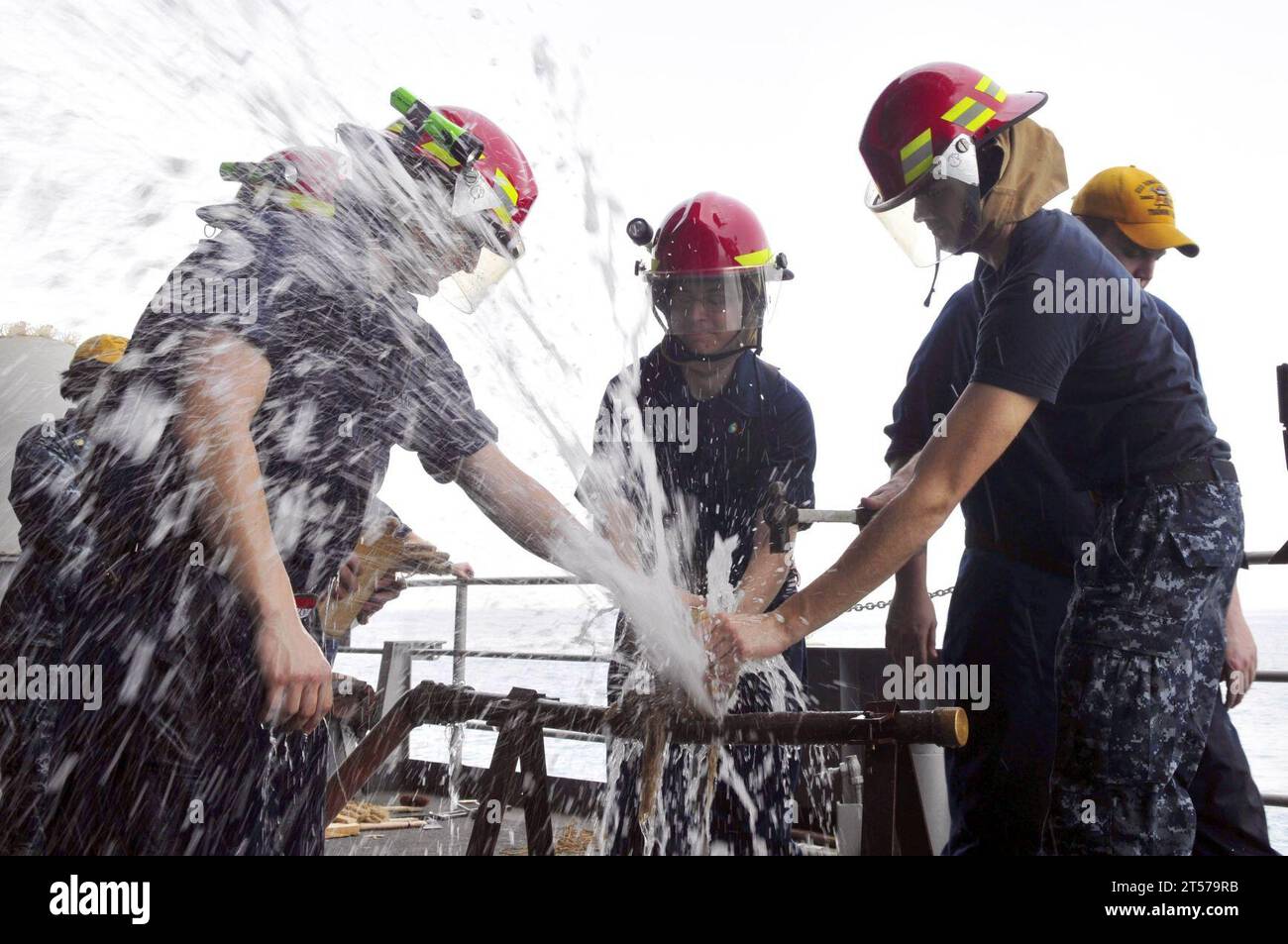 US Navy Sailors patch a pipe during damage control training on the ...