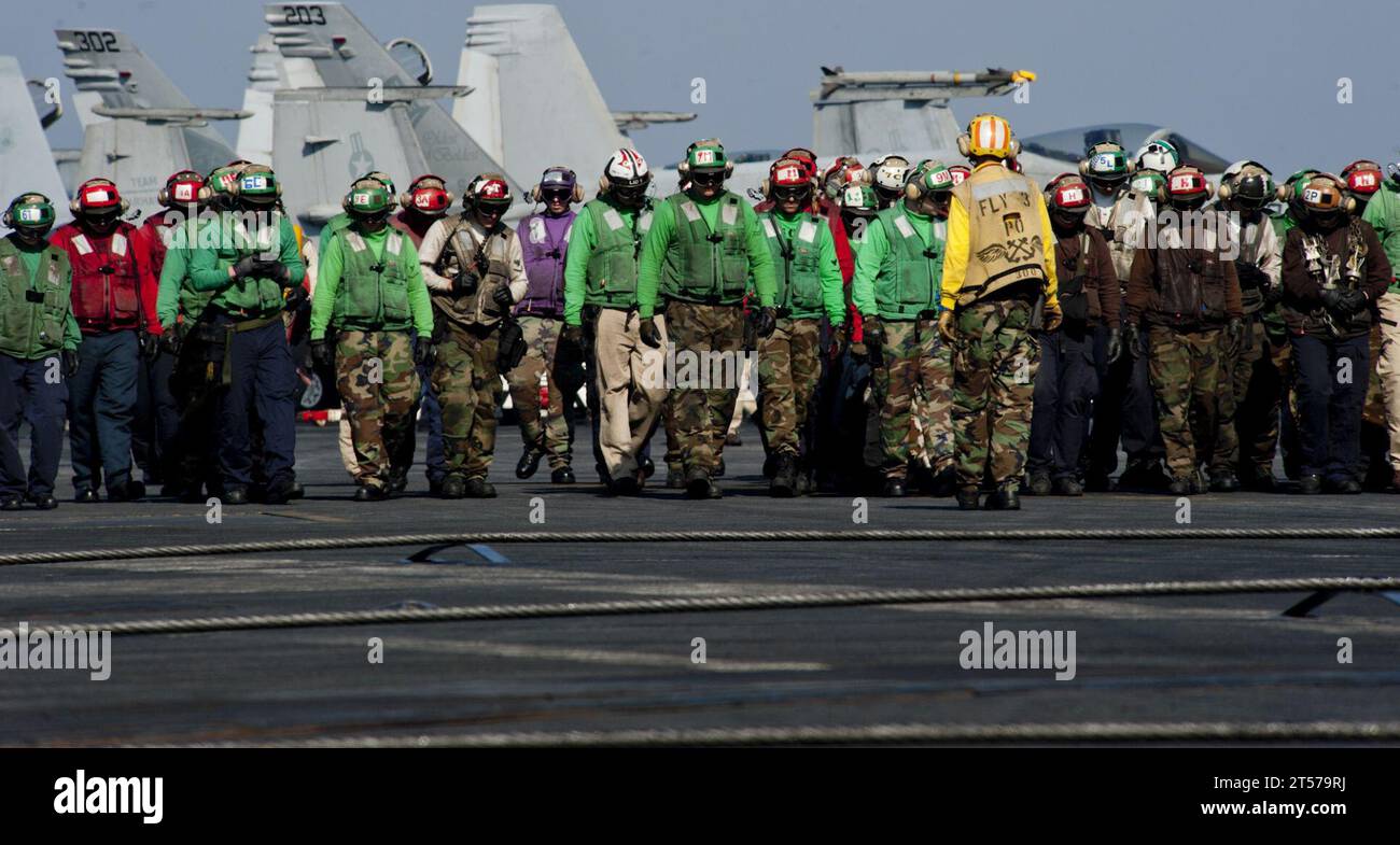 US Navy Sailors perform a foreign object damage walkdown on the flight ...