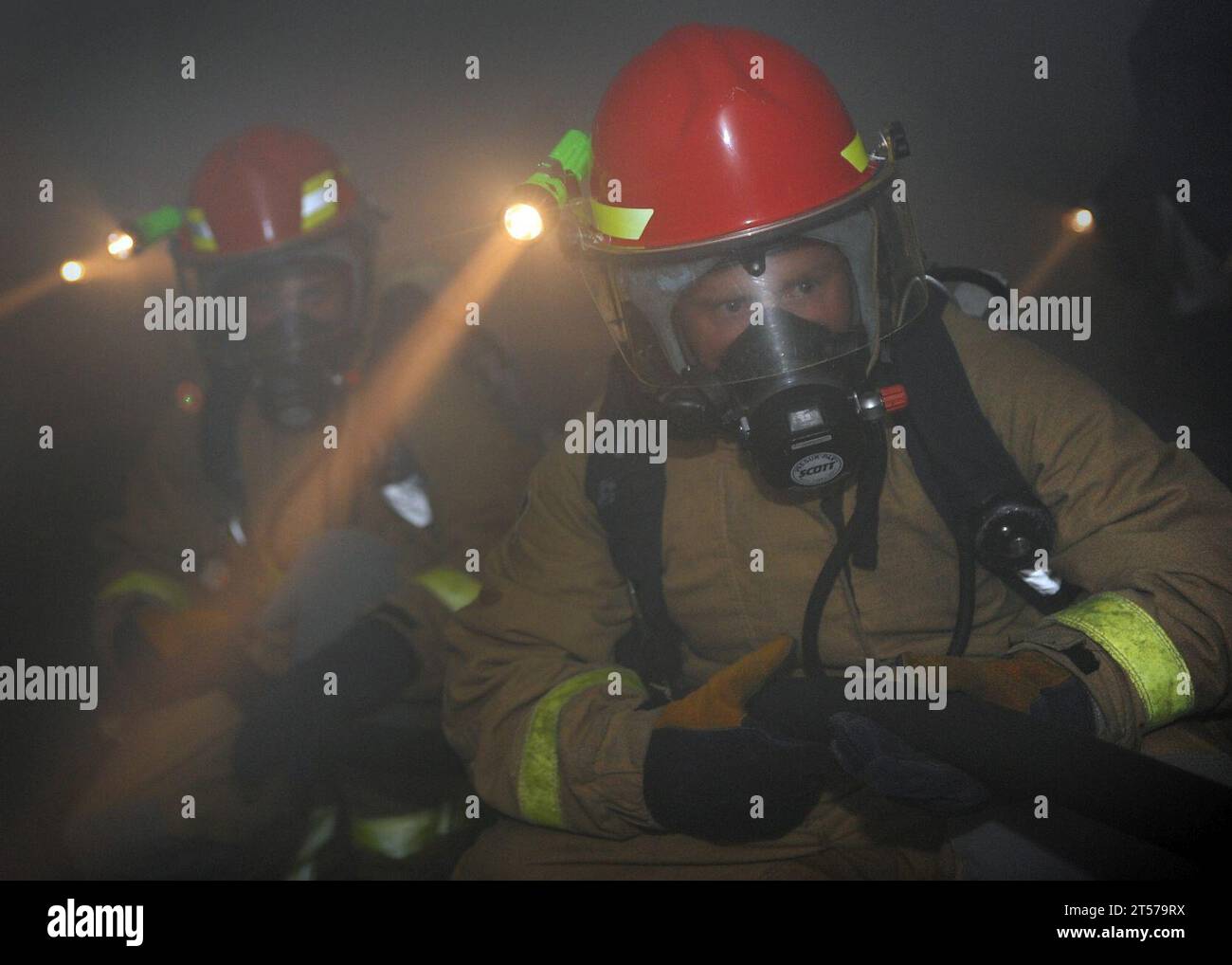 US Navy Sailors participate in a general quarters drill in the hangar ...