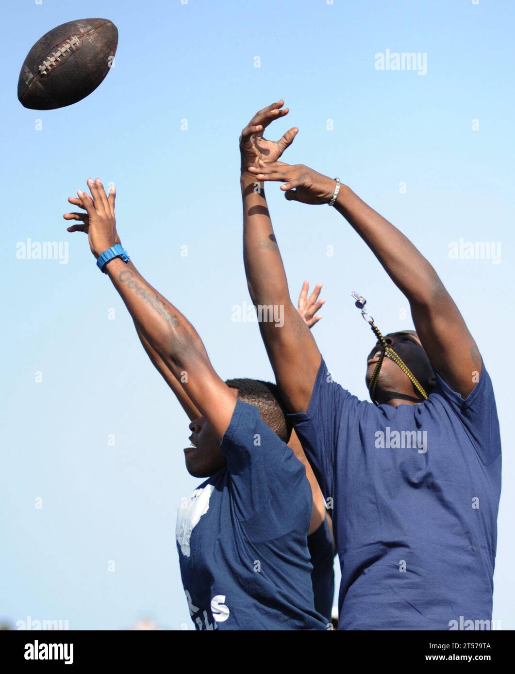 US Navy Sailors play football during a steel beach cook out on the ...