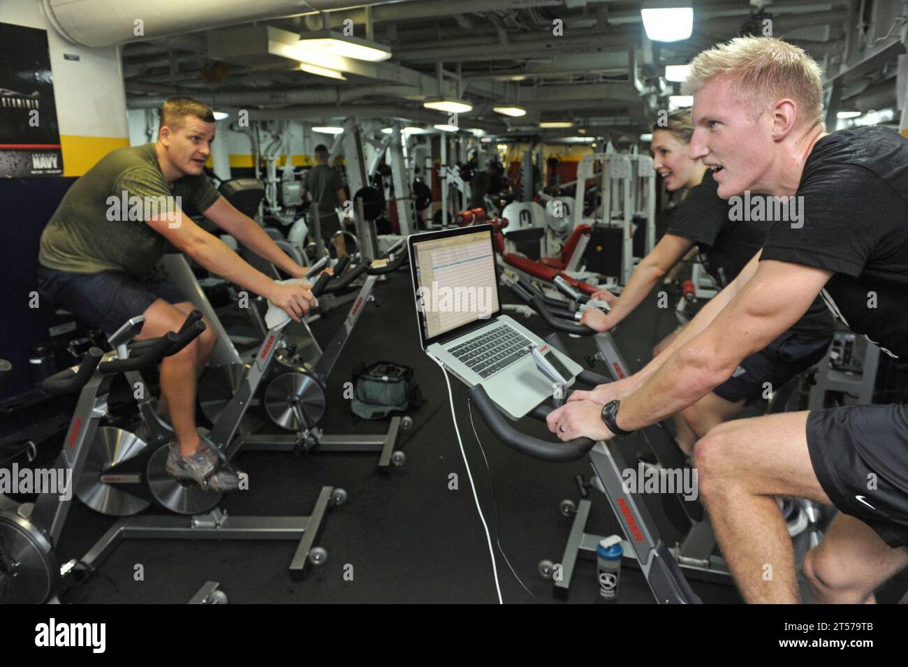 US Navy Sailors participate in a spin class in the gym aboard the ...