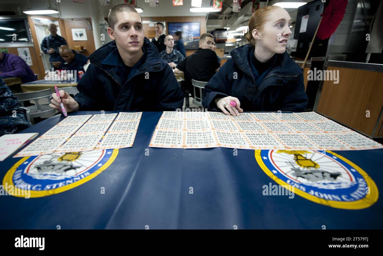US Navy Sailors play bingo on the aft mess decks aboard the Nimitz ...