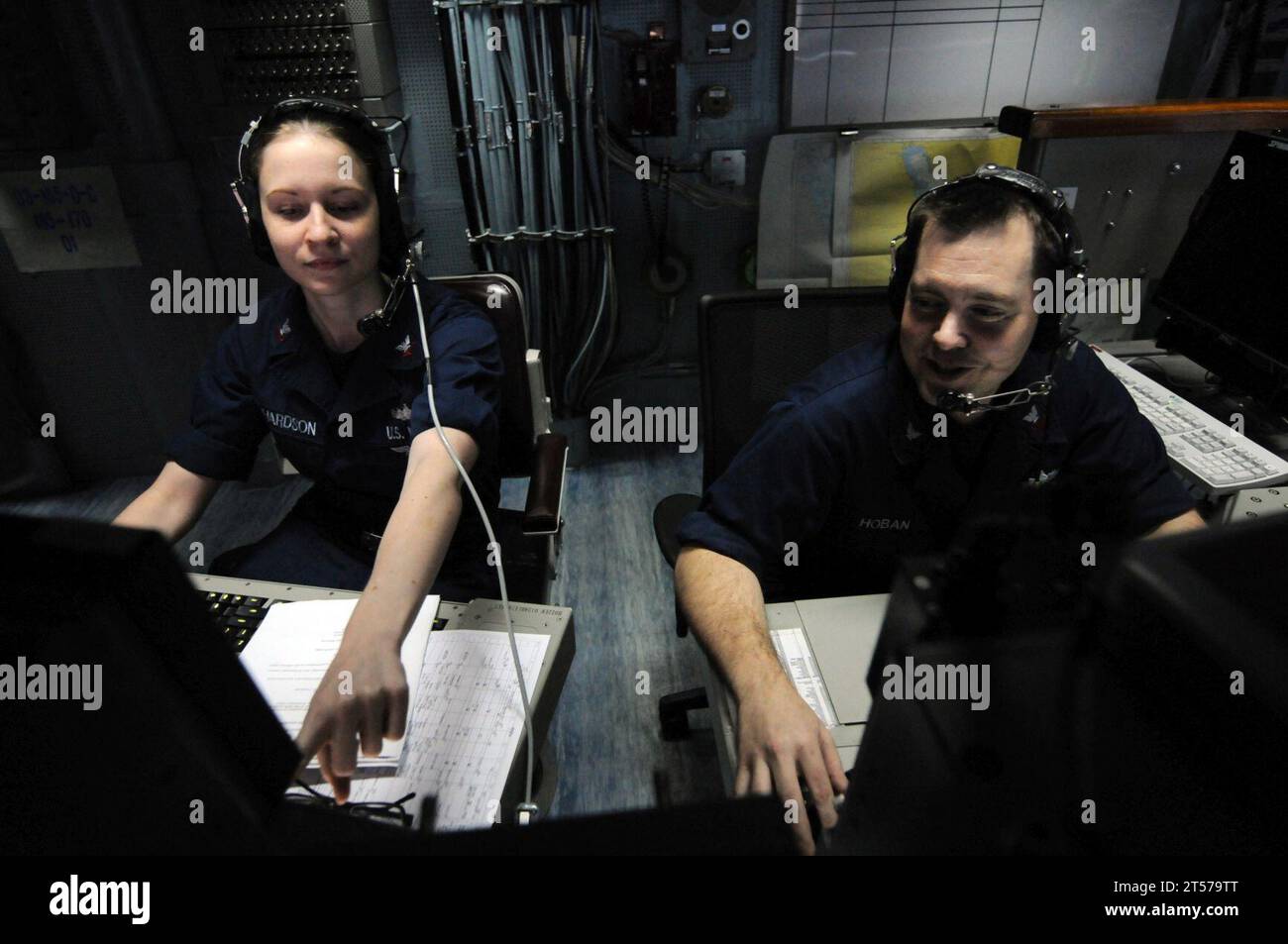 US Navy Sailors plot surface contacts in the combat direction center ...