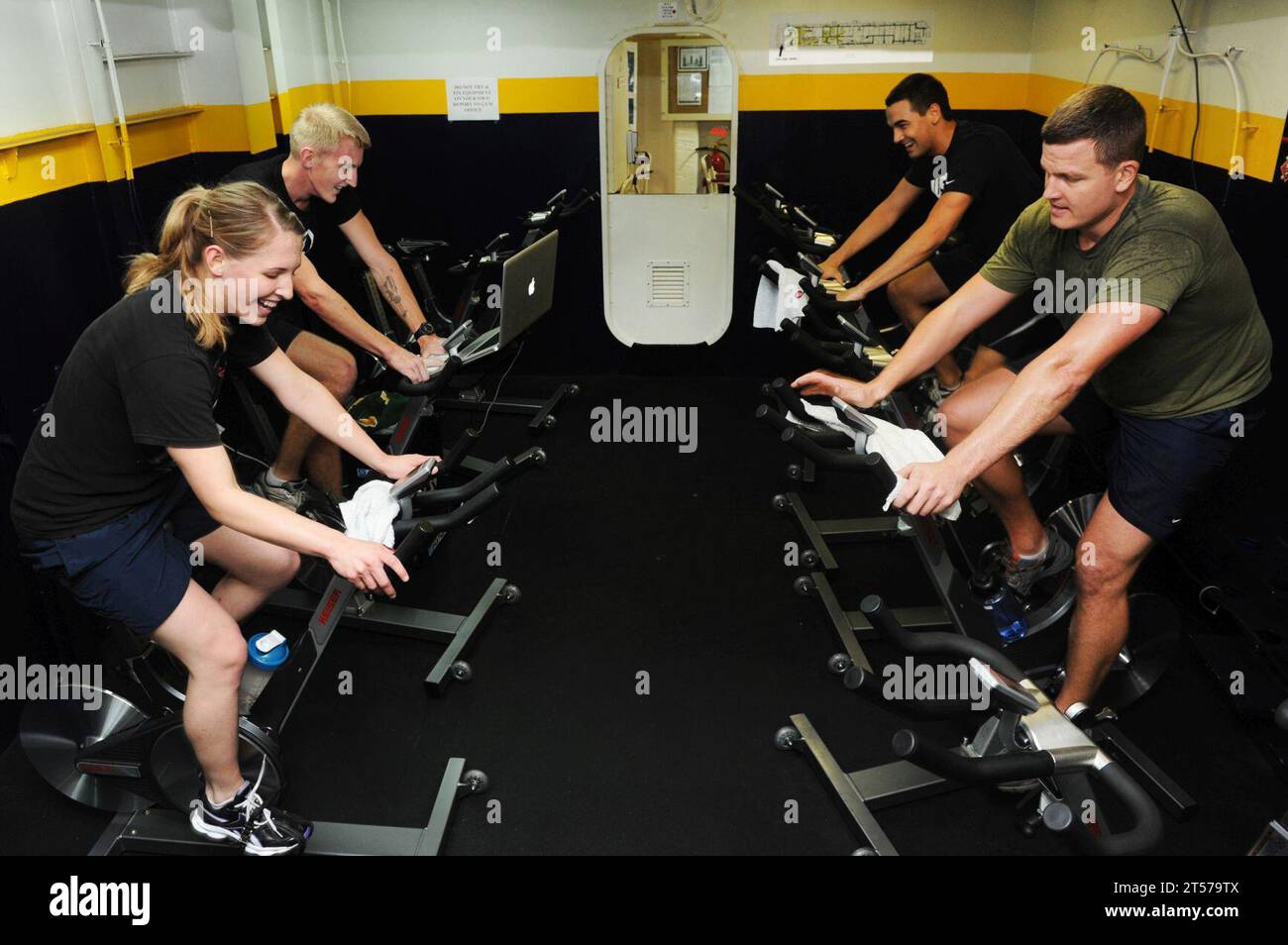 US Navy Sailors participate in a spin class in the gym aboard the ...