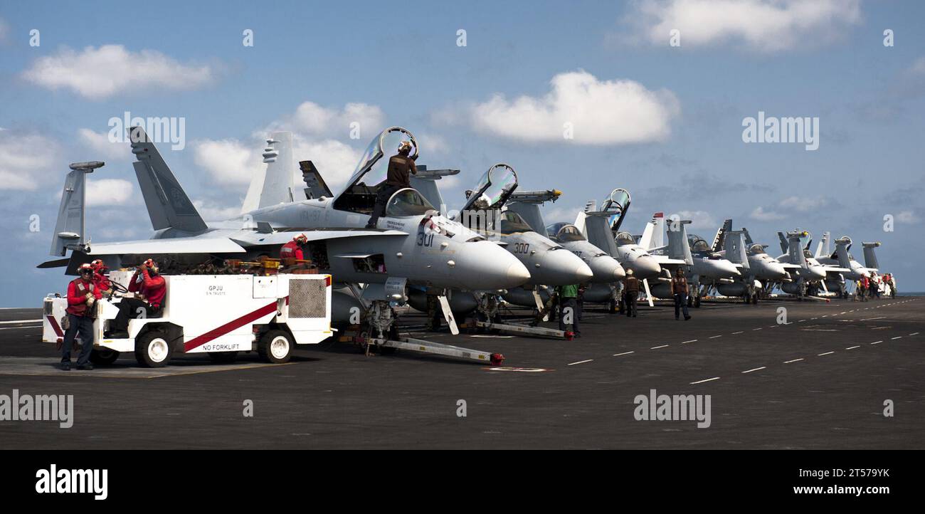 US Navy Sailors prepare the flight deck and aircraft for flight ...