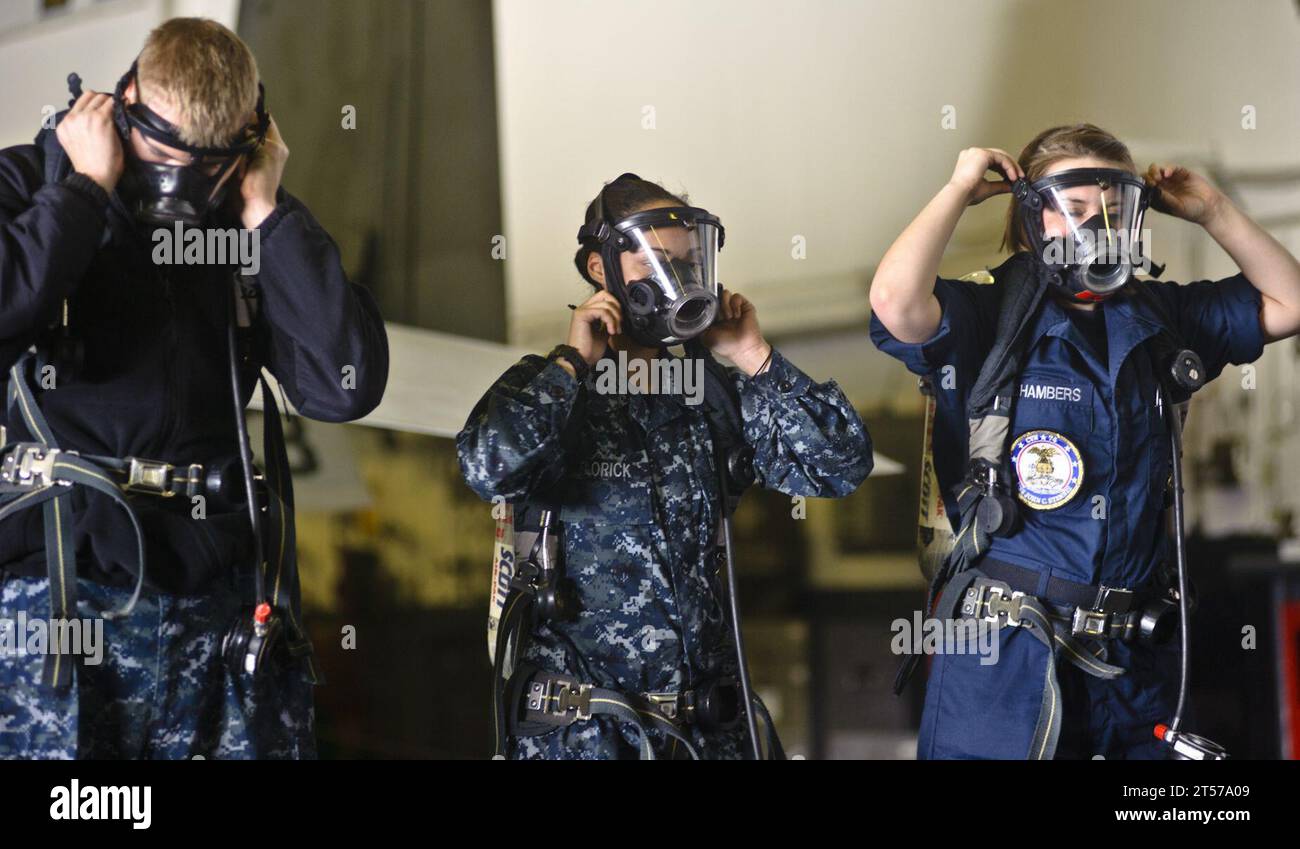 US Navy Sailors practice proper donning of self-contained breathing ...