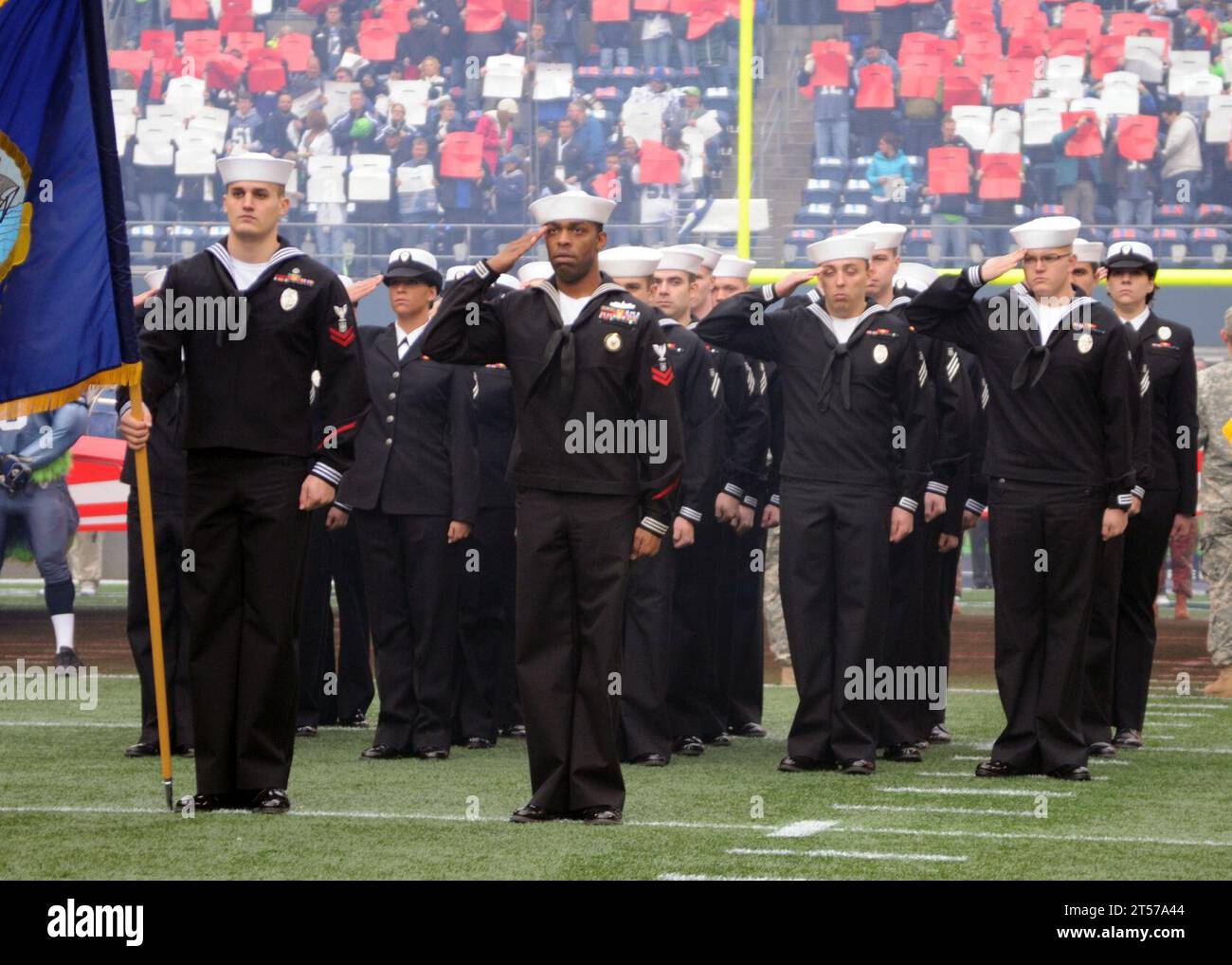US Navy Sailors salute during the national anthem during a Military ...