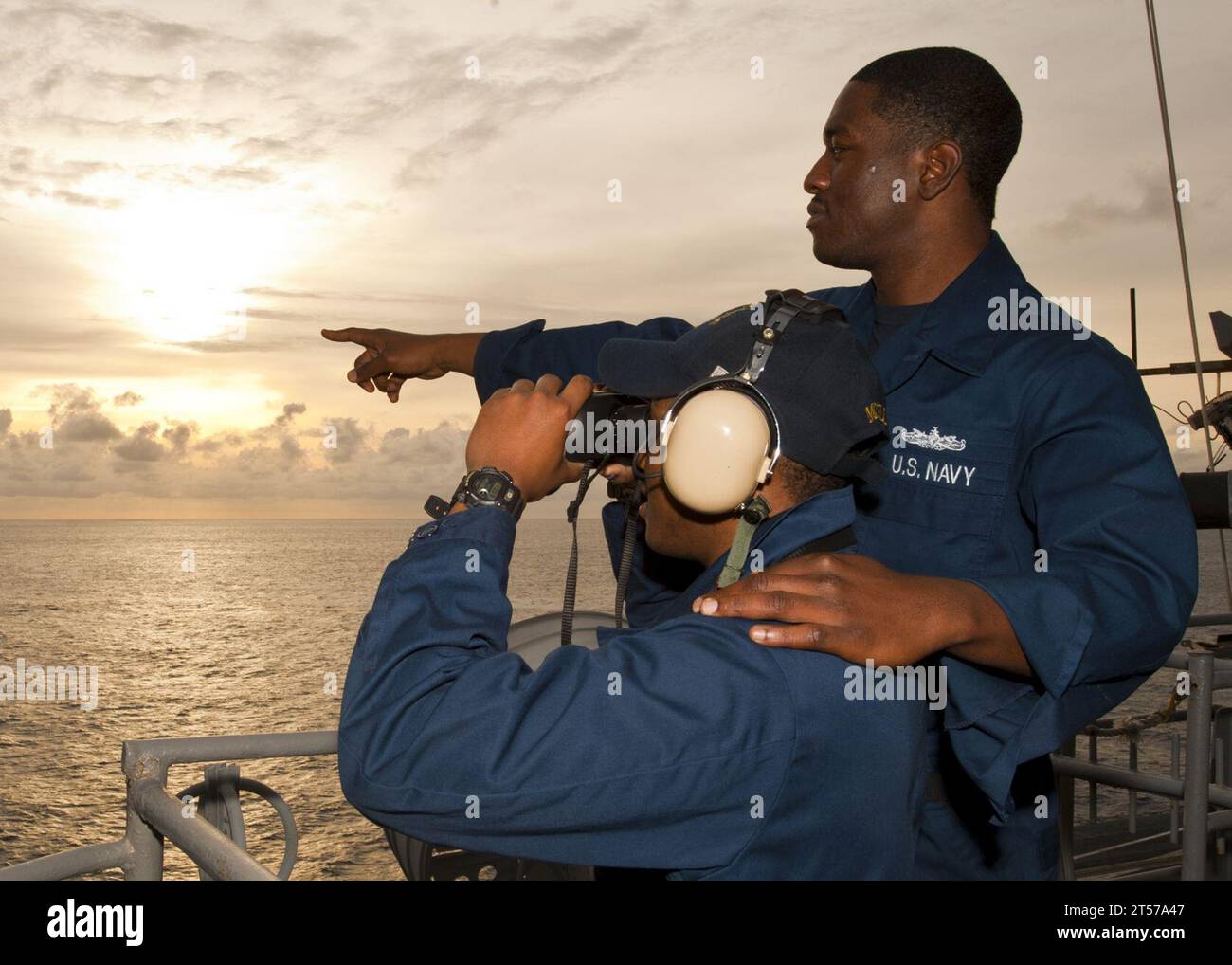 US Navy Sailors scan the horizon for surface contacts while on watch ...
