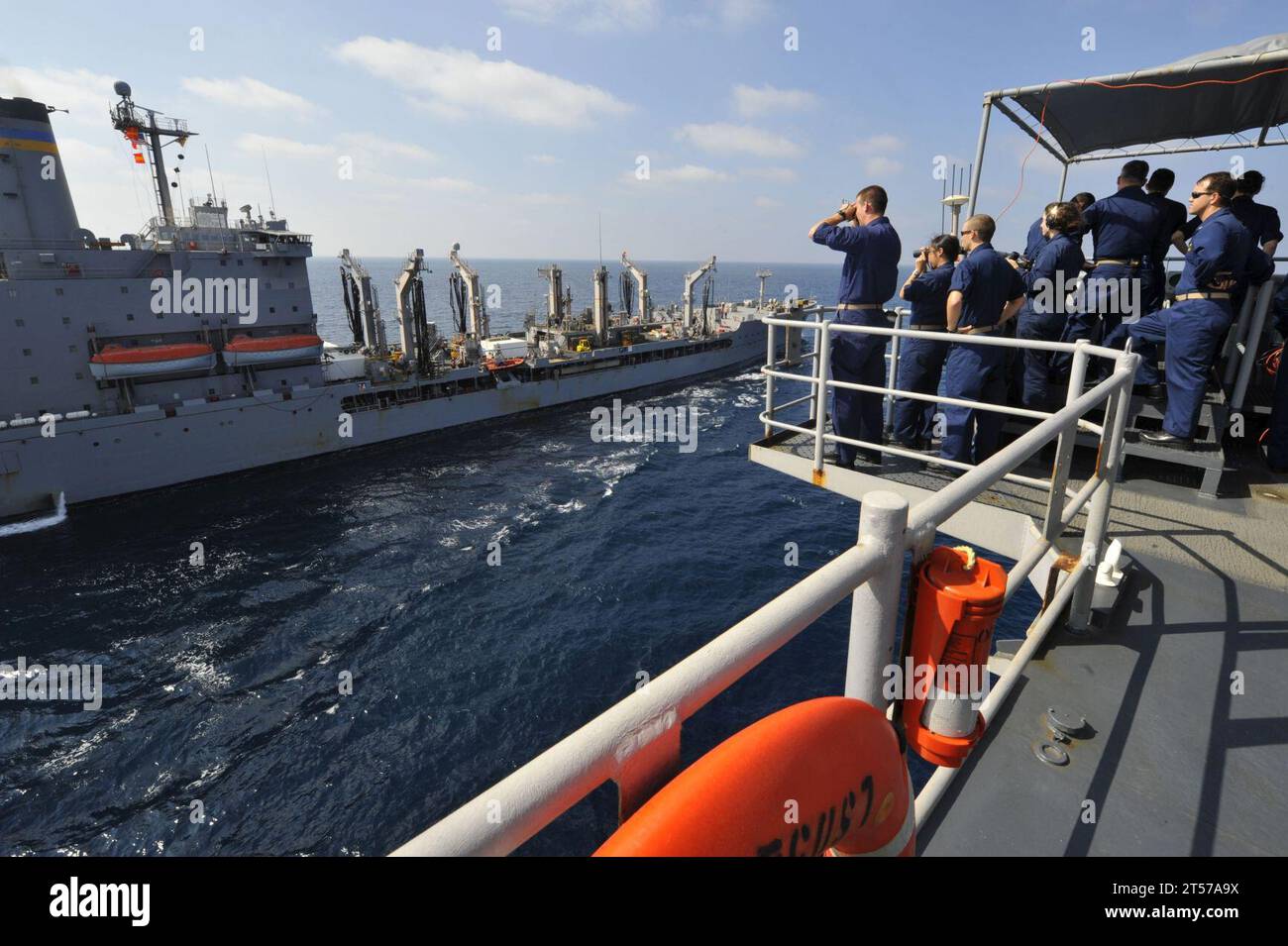 US Navy Sailors stand watch on the bridge wing of amphibious dock ...