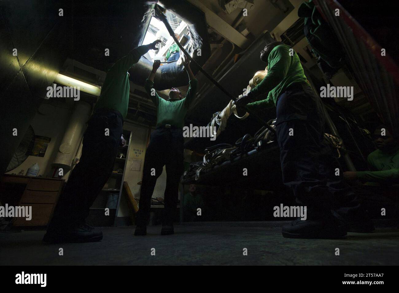 US Navy Sailors stow barricades below decks after flight deck drills ...