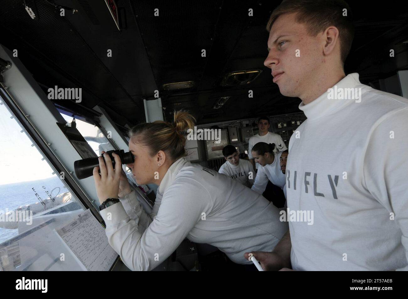 US Navy Sailors watch from primary flight control as an F18C Hornet ...