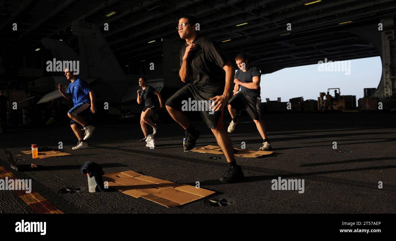US Navy Sailors workout in hangar bay three aboard the Nimitz-class ...