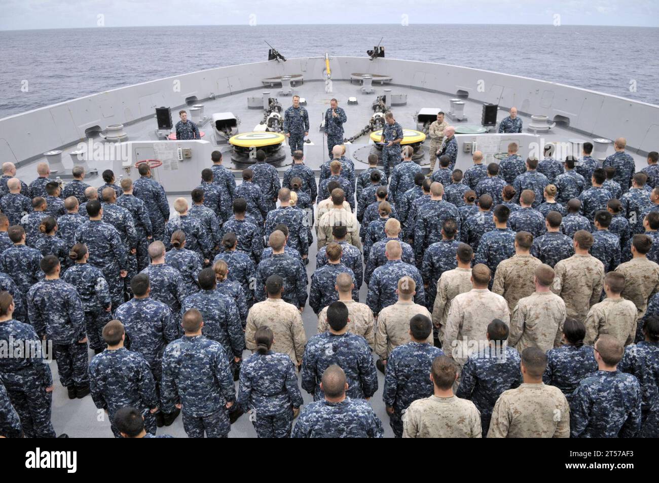 US Navy Sailors, Marines stand at attention on the foc'sle for an all ...