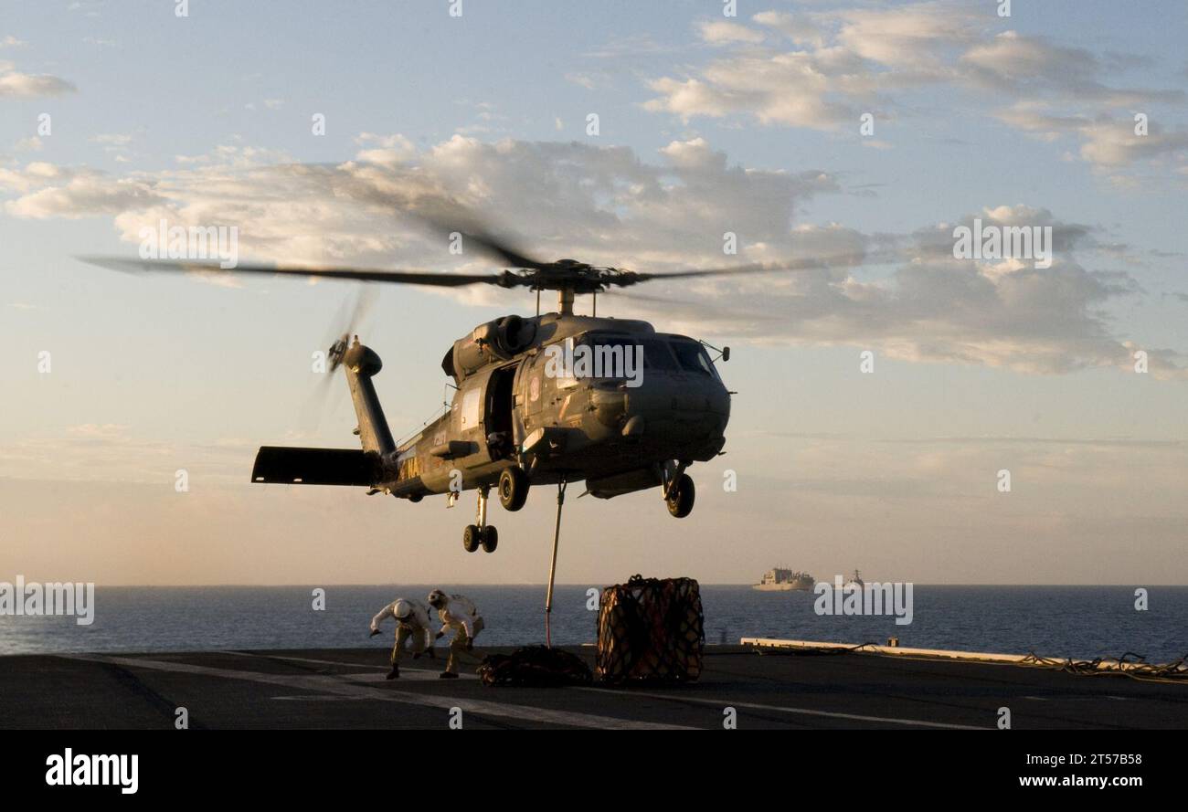 US Navy Supply department Sailors run clear after securing cargo to an ...