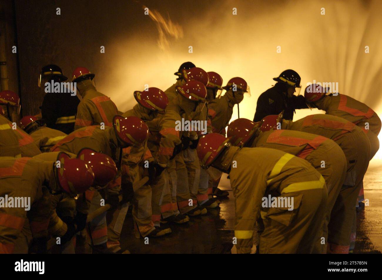 US Navy Surface Warfare Officer's School (SWOS) students man fire hoses ...