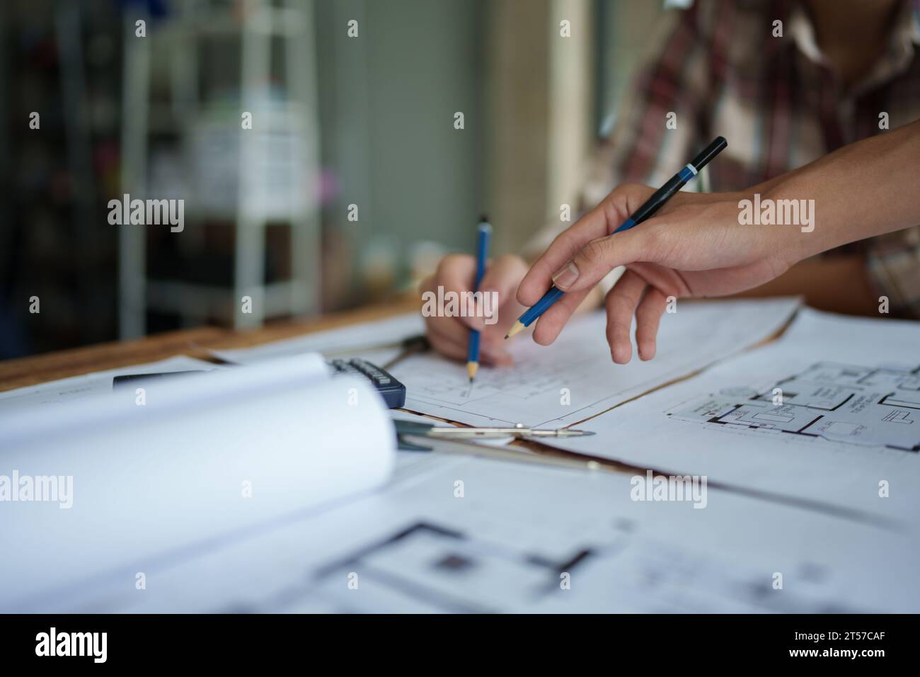 multi ethnic engineer brainstorming and measuring for cost estimating ...