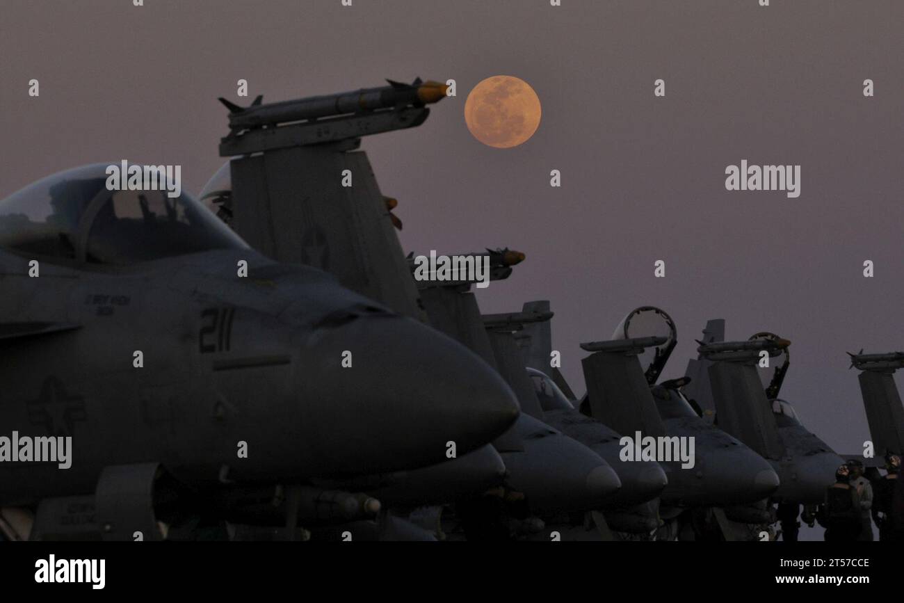 US Navy The moon rises over aircraft on the flight deck aboard the ...