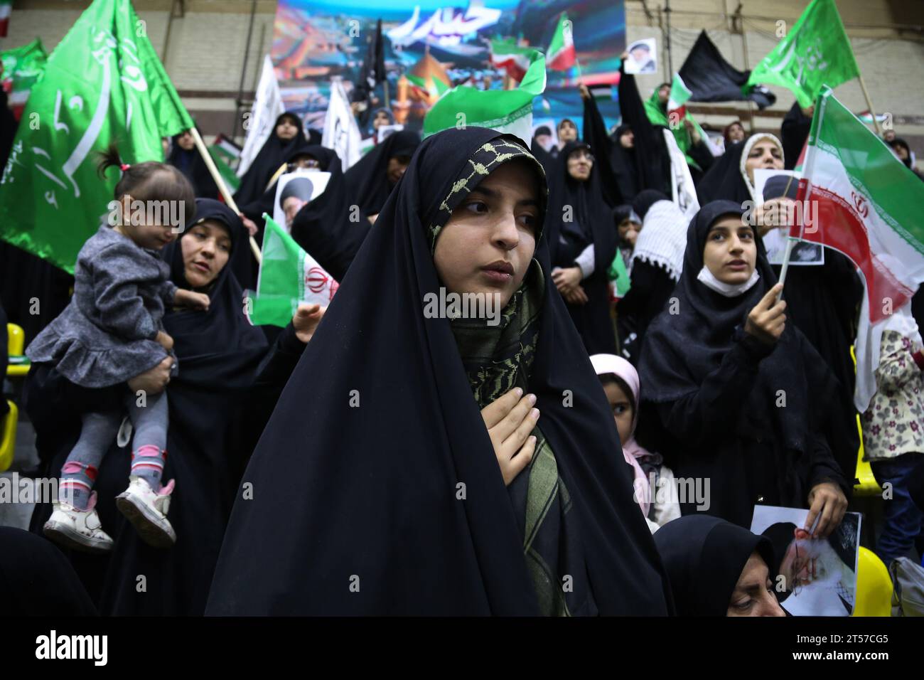 Tehran, Iran. 2nd Nov, 2023. Iranian veiled women wave Iranian flags ...