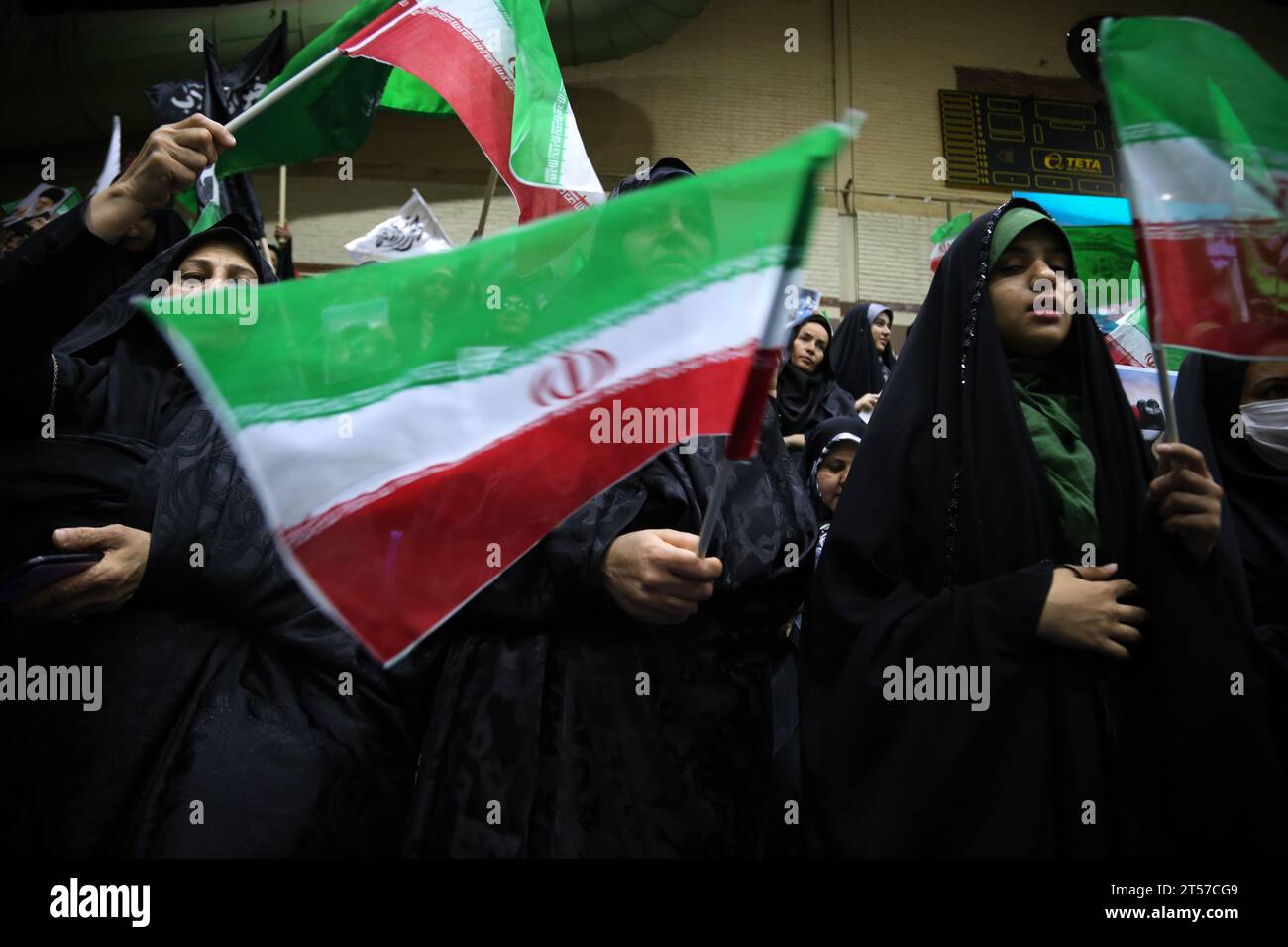 Tehran, Iran. 2nd Nov, 2023. Iranian veiled women wave Iranian flags ...
