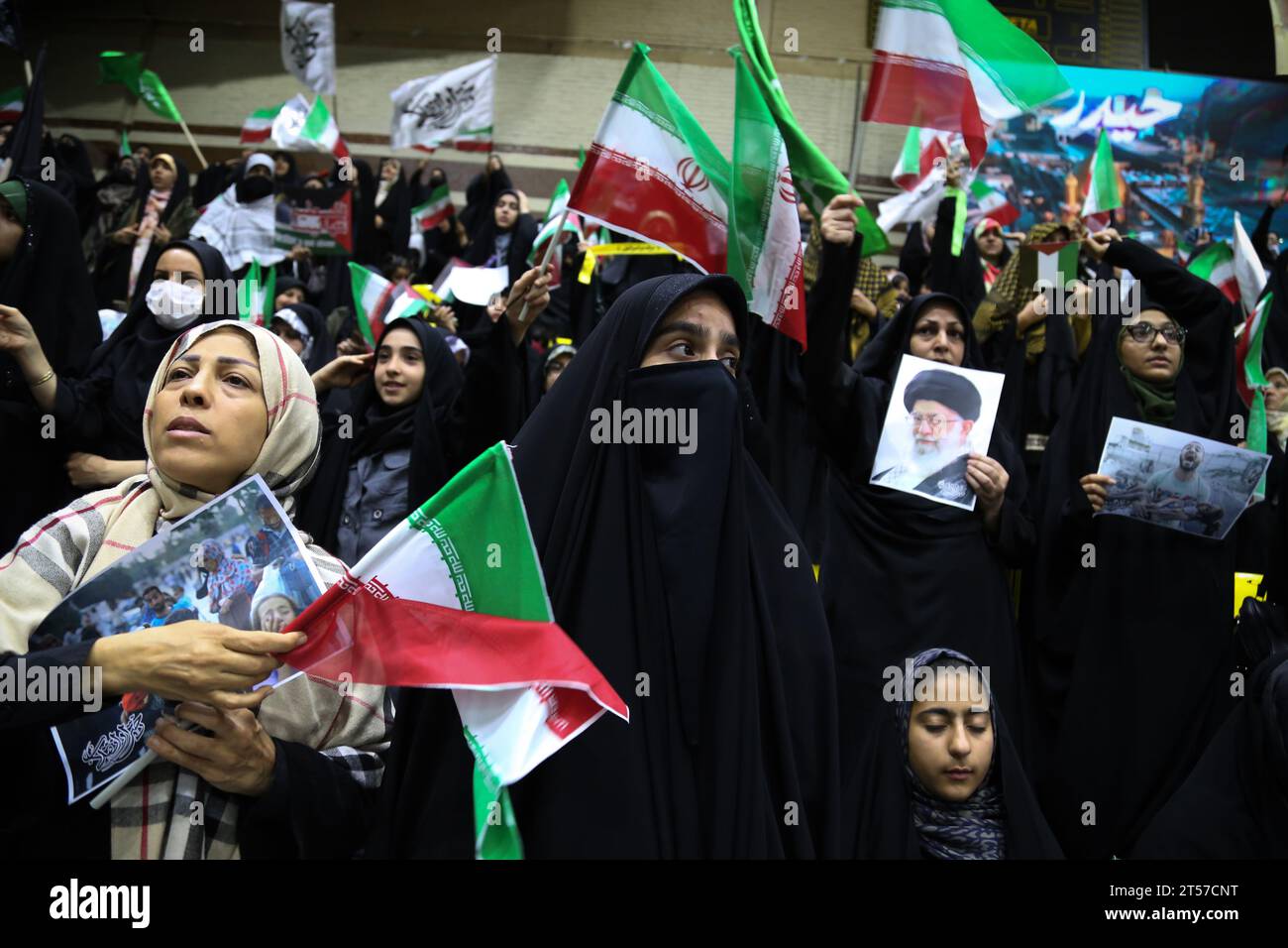 Tehran, Iran. 2nd Nov, 2023. Iranian veiled women wave Iranian flags ...