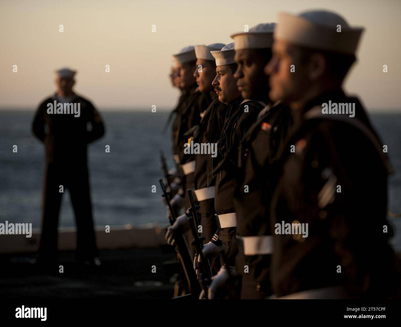 US Navy The rifle detail stands at parade rest during a burial at sea ...