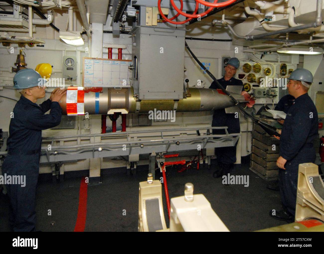 US Navy The torpedo handling team removes a MK46 Torpedo from the ...