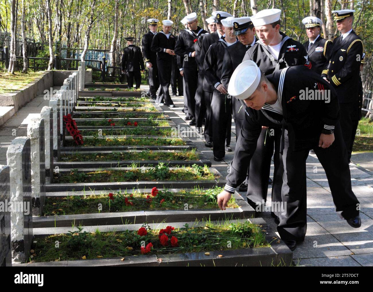 US Navy U.S. Navy Sailors place flowers at the graves of American ...