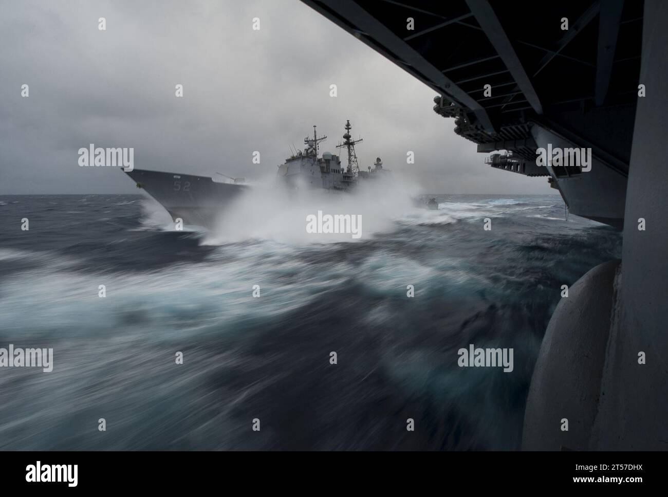 US Navy USS Bunker Hill pulls away after taking on fuel in heavy seas ...