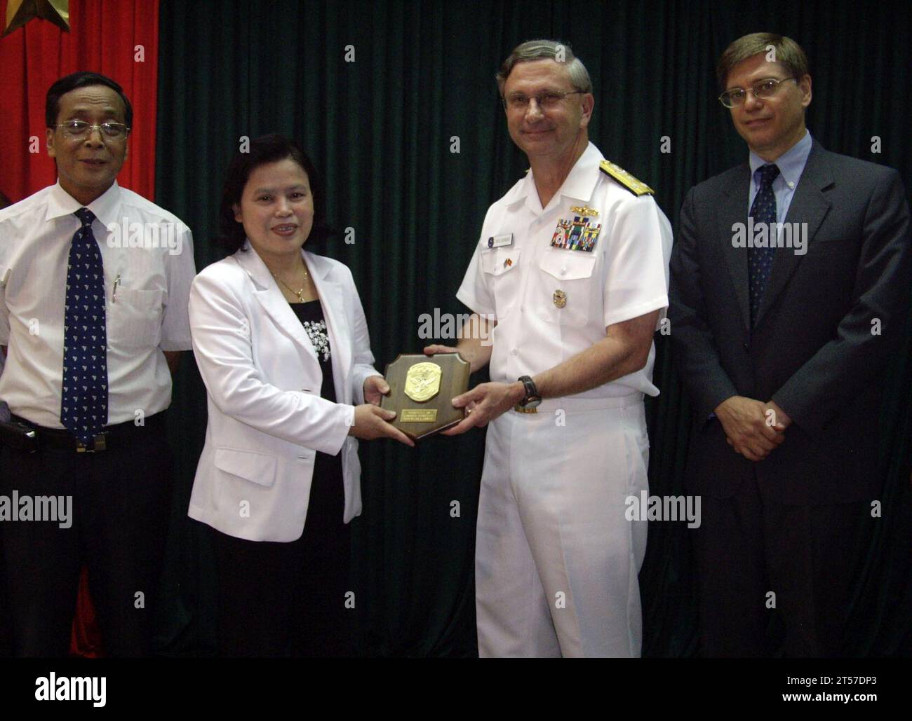 US Navy Vice Adm. Doug Crowder, commander, U.S. 7th Fleet, presents a ...