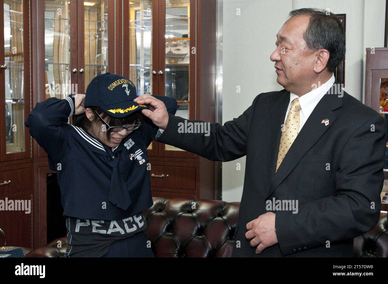 US Navy Visitors from Japan receive command ball caps from the CO of U ...