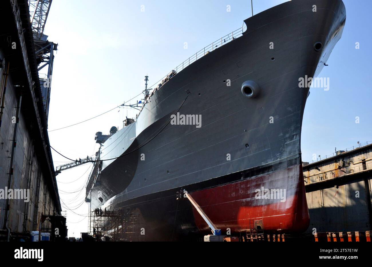 US Navy Workers from the Viktor Lenac shipyard apply red paint to the ...