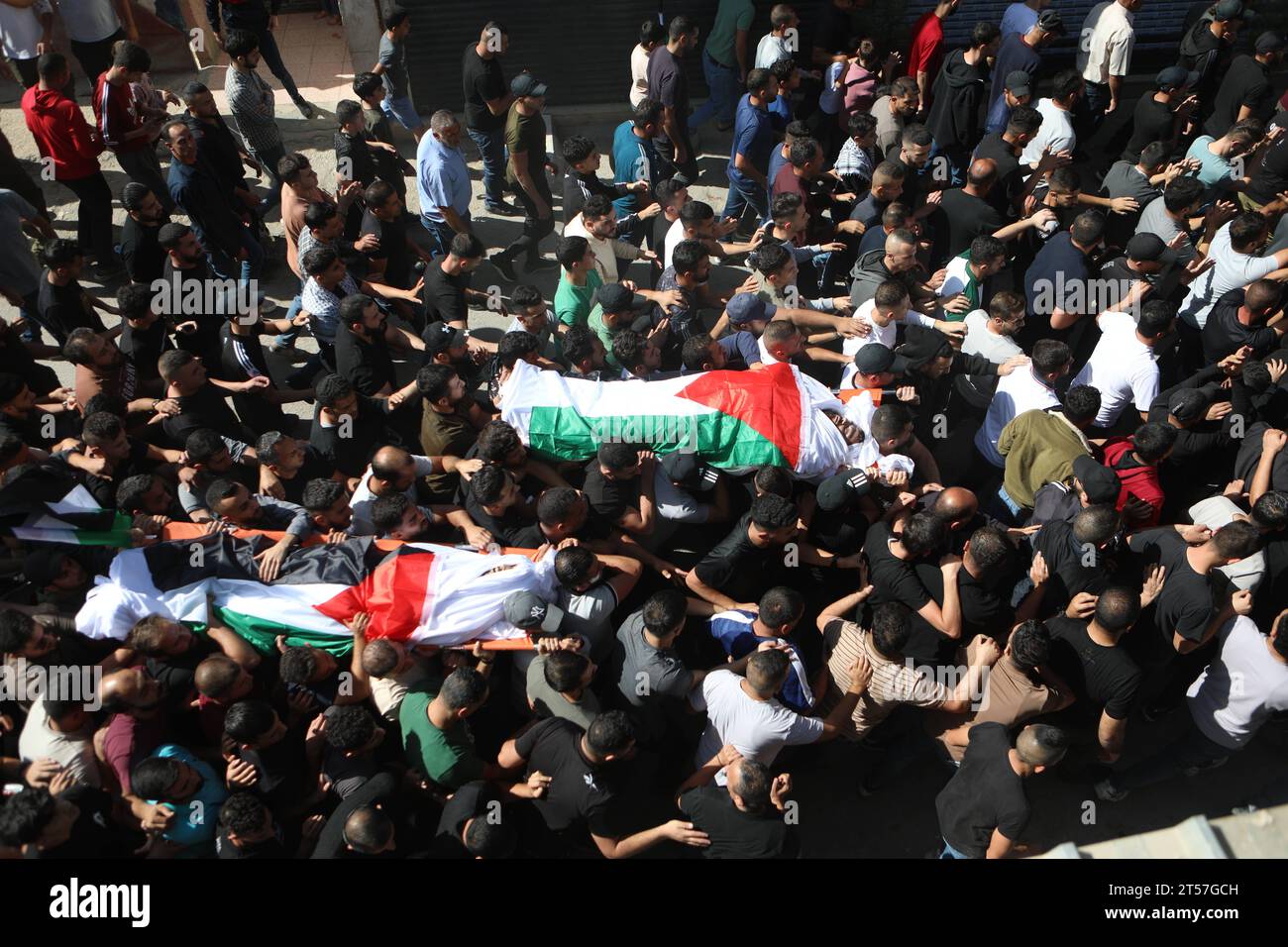 Mourners carry the bodies of two Palestinians Muhammed Saaid Al-Azeh ...