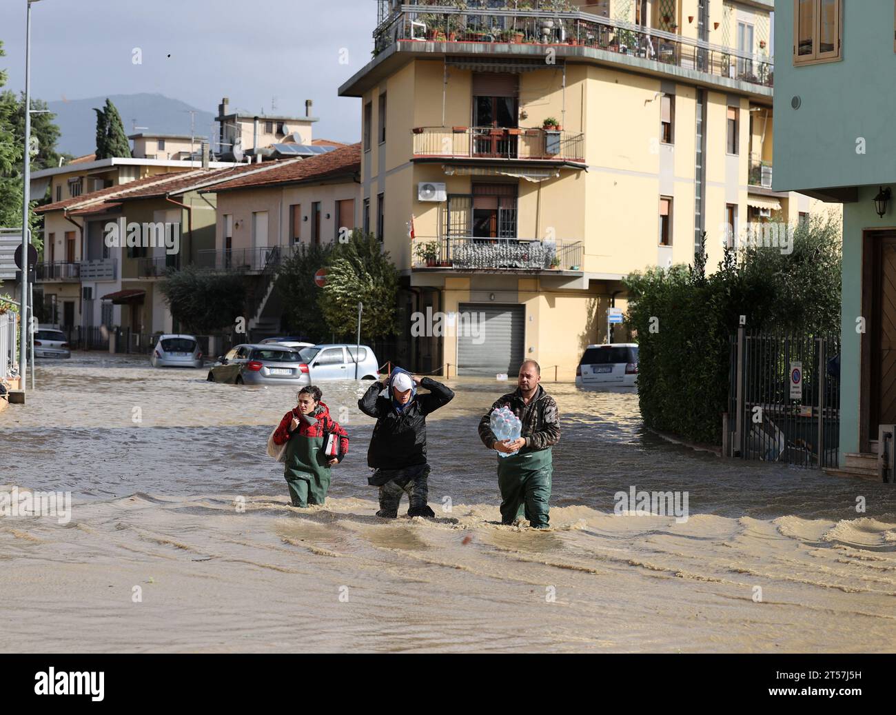 Tuscany, Italy. 3rd Nov, 2023. People walk in flood water in Tuscany ...