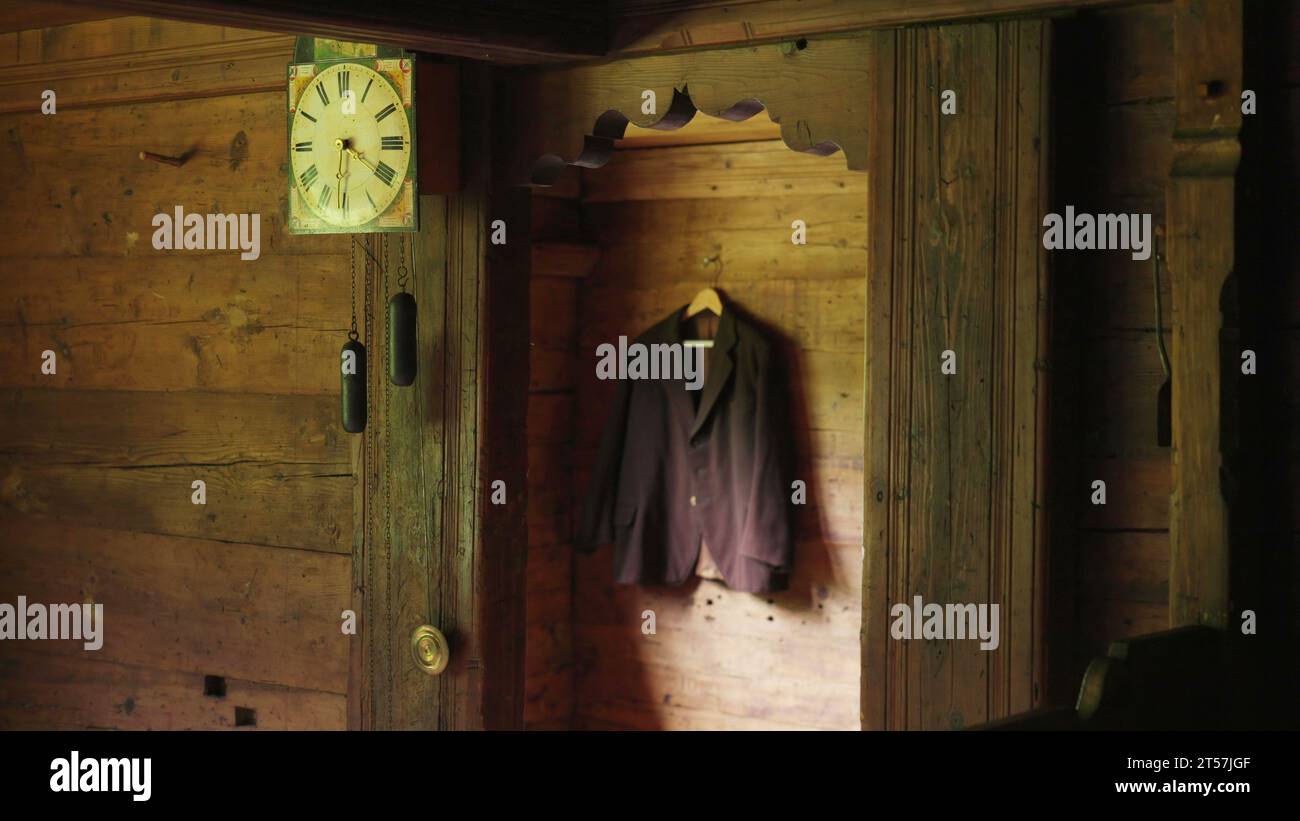 Vintage alpine suit displayed on Chalet timber wall. Traditional rural ...