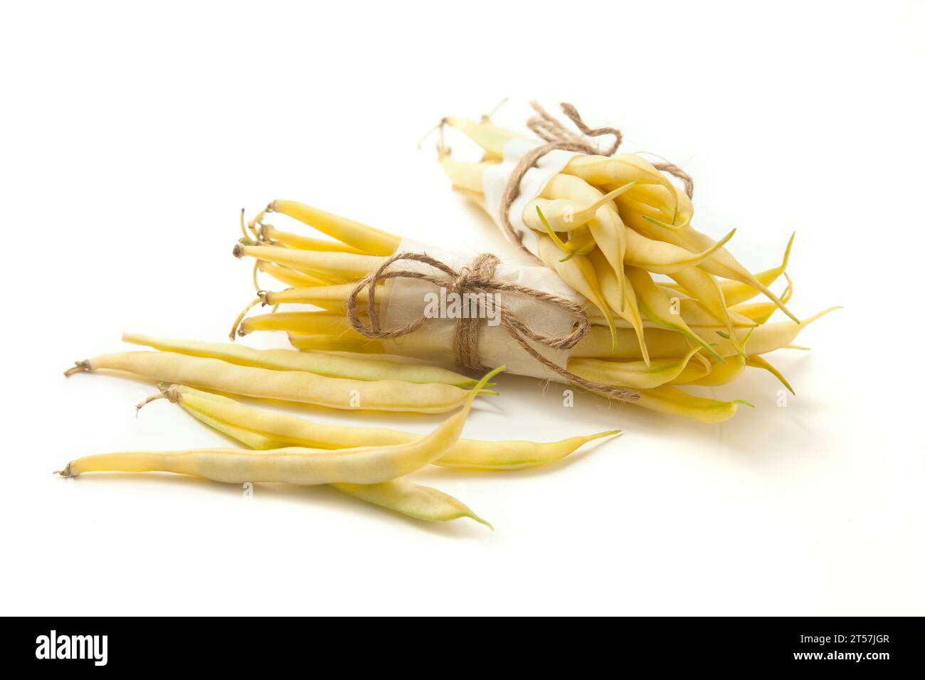 Two bunches and small pile of raw yellow pods of haricot isolated on ...