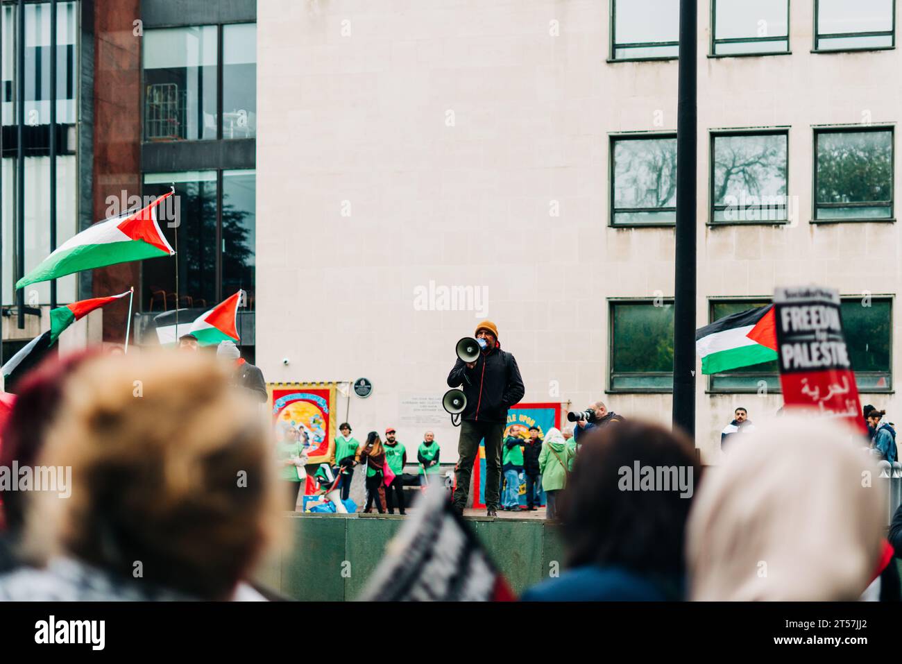 Male speaker addresses crowd at pro-Palestine march with Palestinian ...