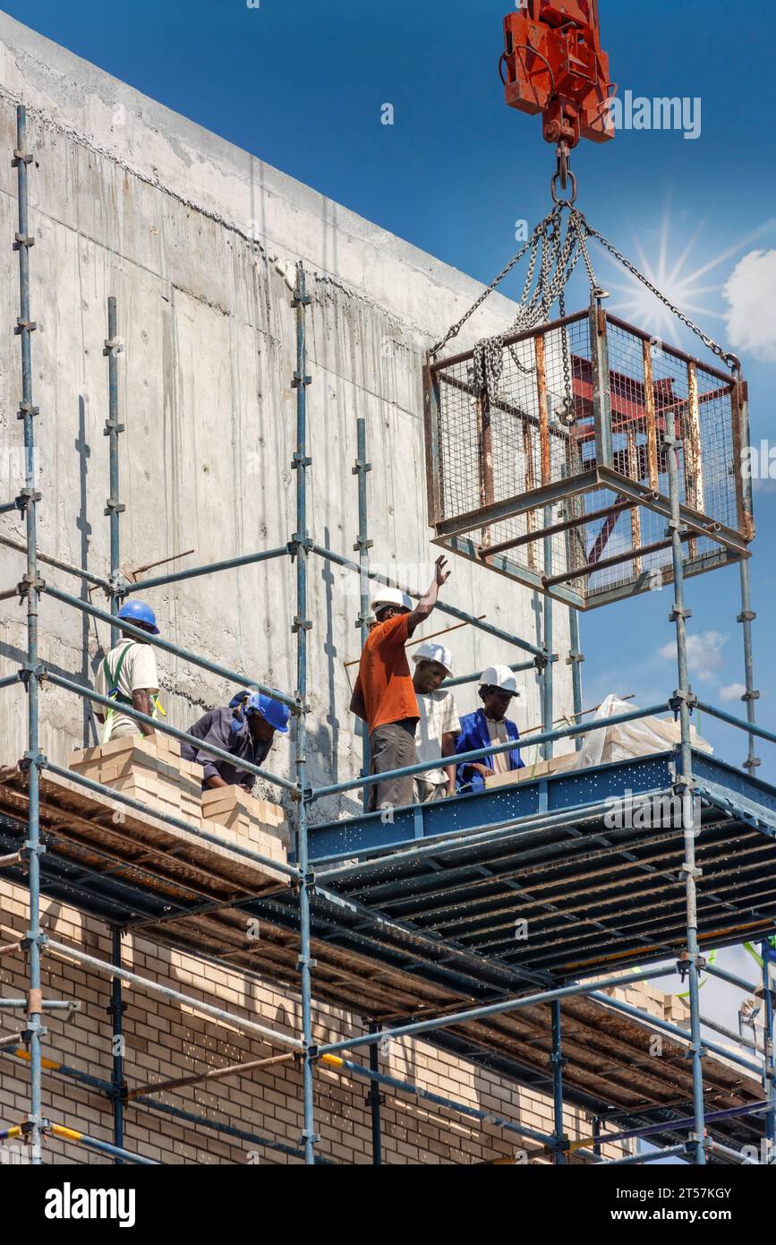 a team of african american construction workers on the scaffolding ...