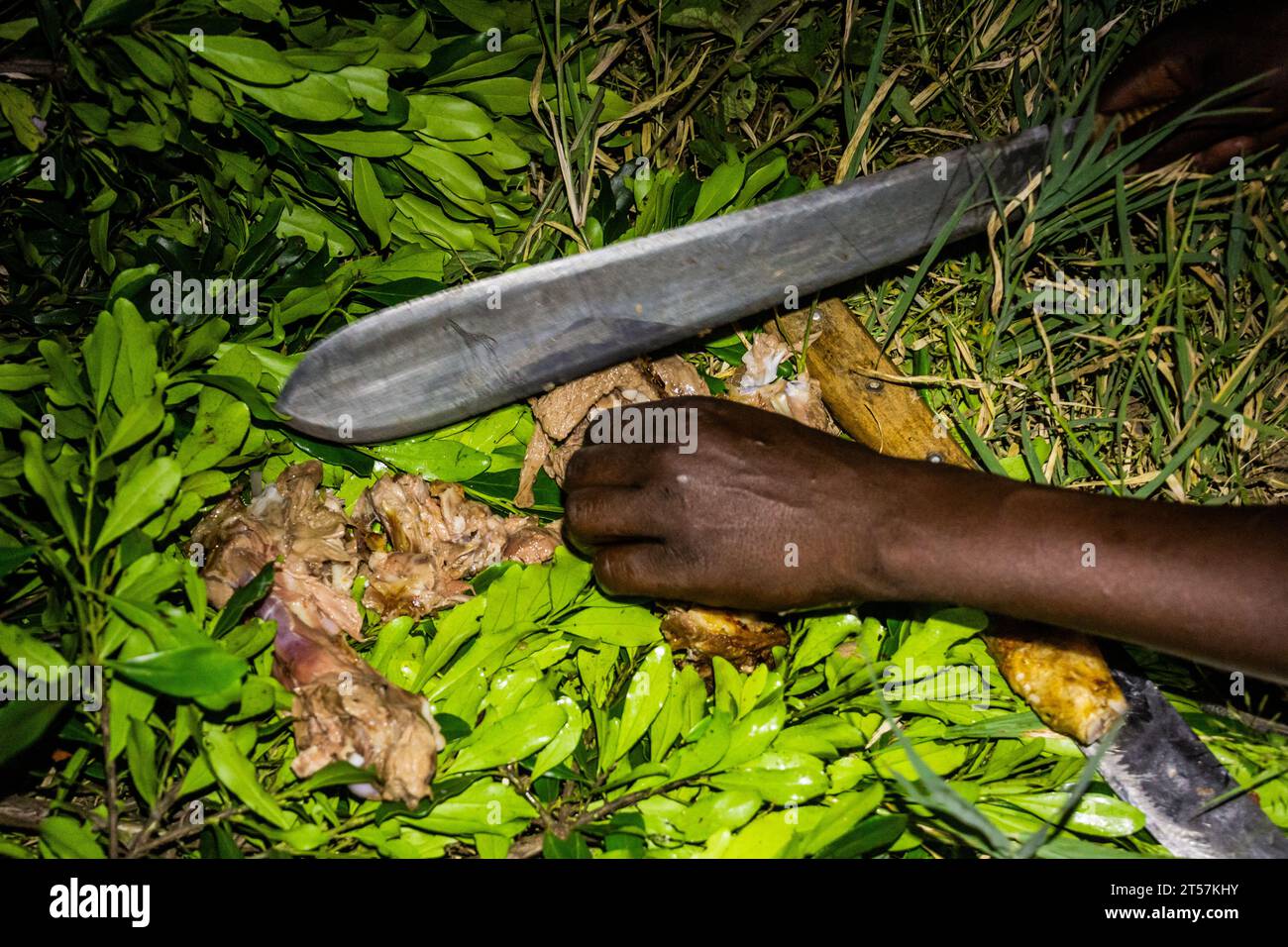 Masai man cutting a goat leg, Kenya Stock Photo - Alamy