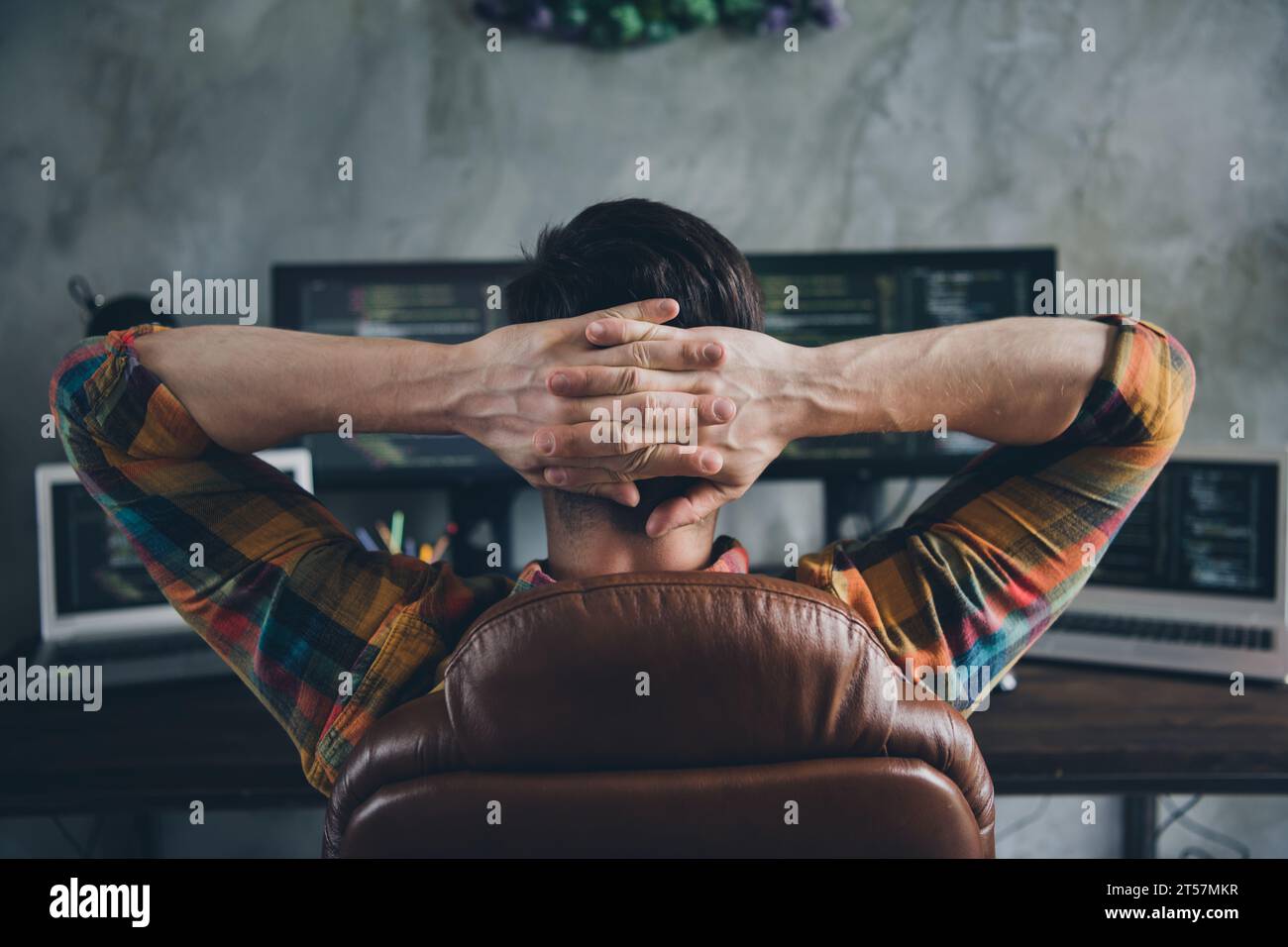 Rear behind photo of cyber security expert sit chair hands behind head ...