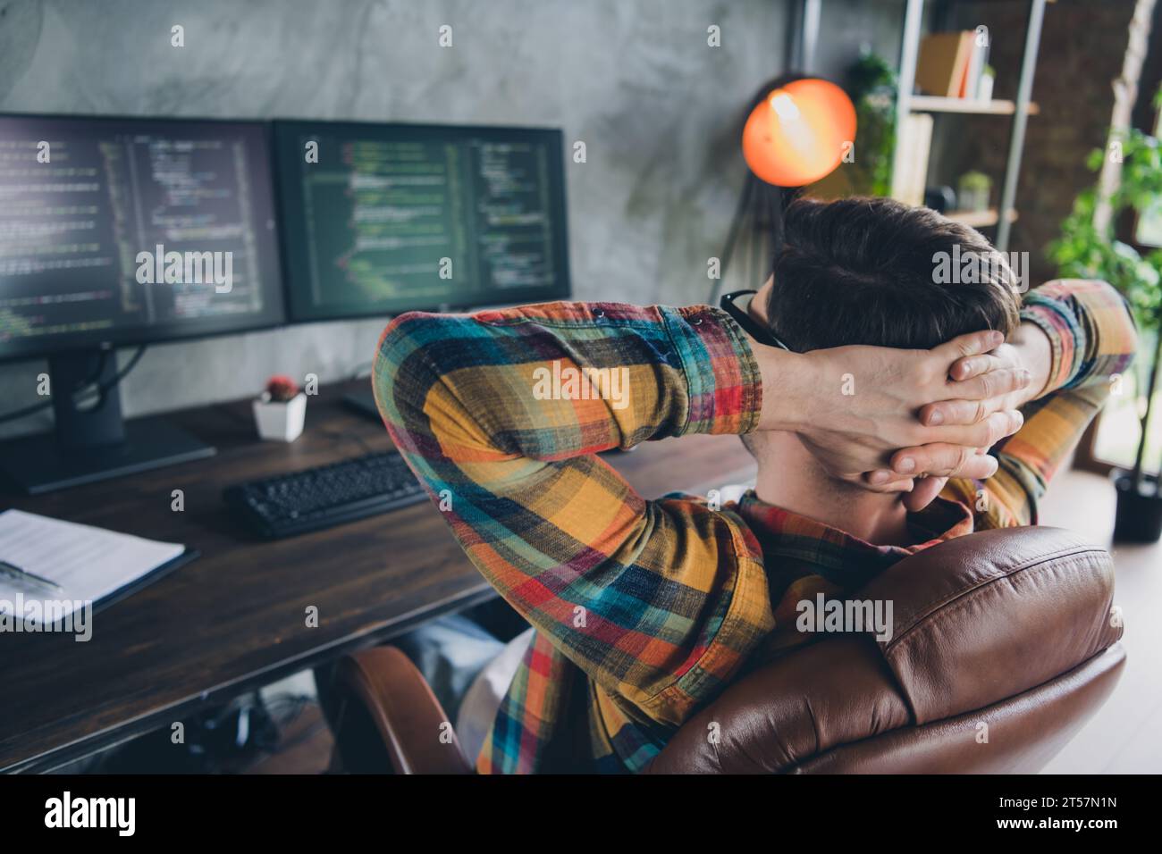 Rear behind photo of successful web designer sitting chair arms behind ...