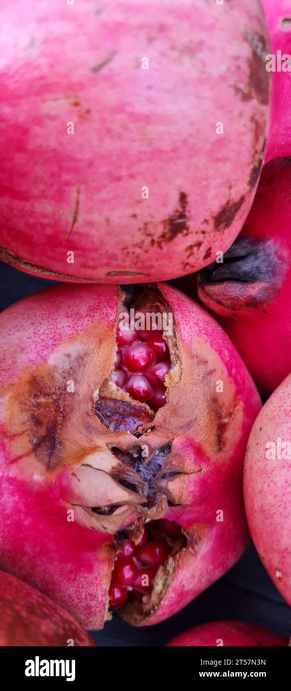 Close up shot of a vibrant mix of pomegranates, featuring bright pink ...