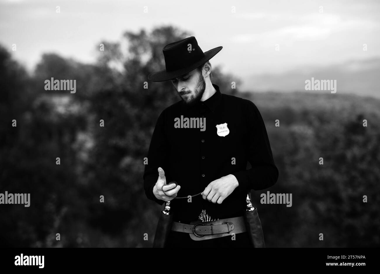 Sheriff or cowboy in black suit. Man with vintage pistol revolver and ...