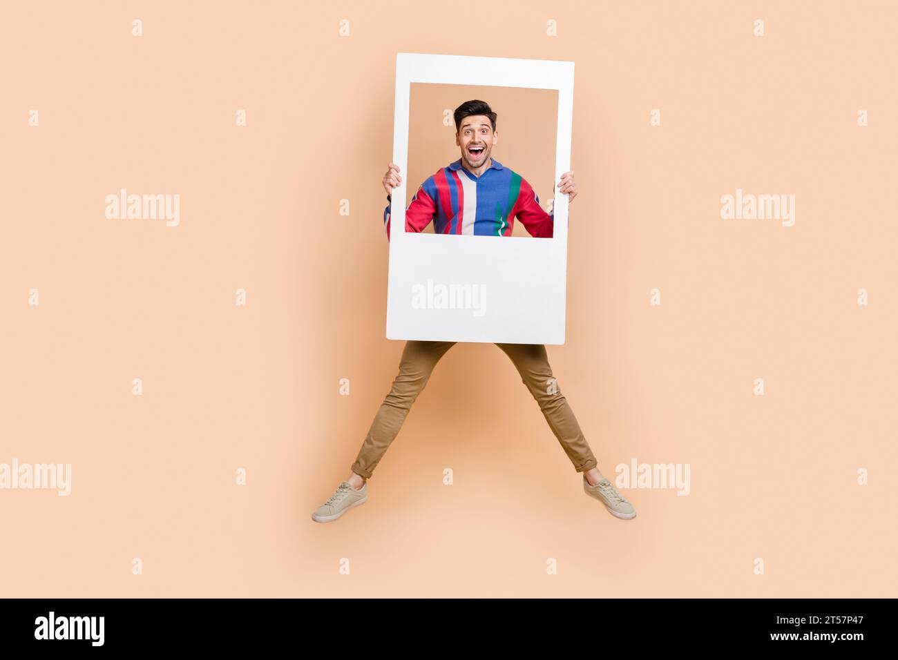 Full body photo of jumping crazy guy have fun holding huge paper zone ...