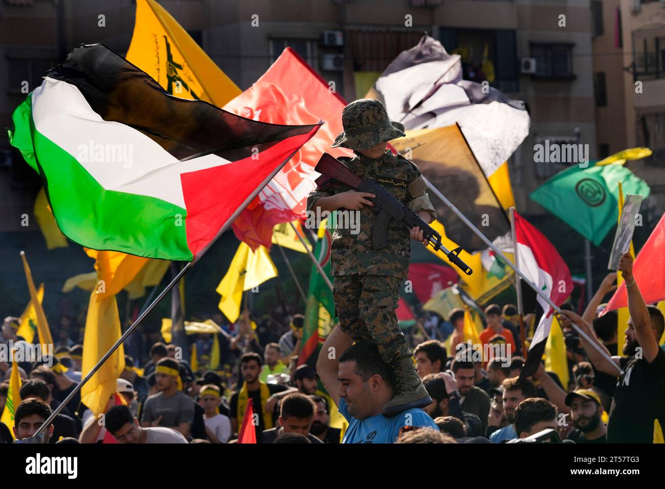 A supporter of the Iranian-backed Hezbollah group carries on his ...