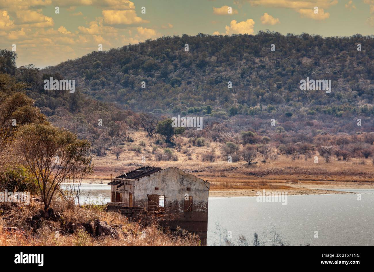 lake at sunset, submerged old house in the water, flooded, near ...