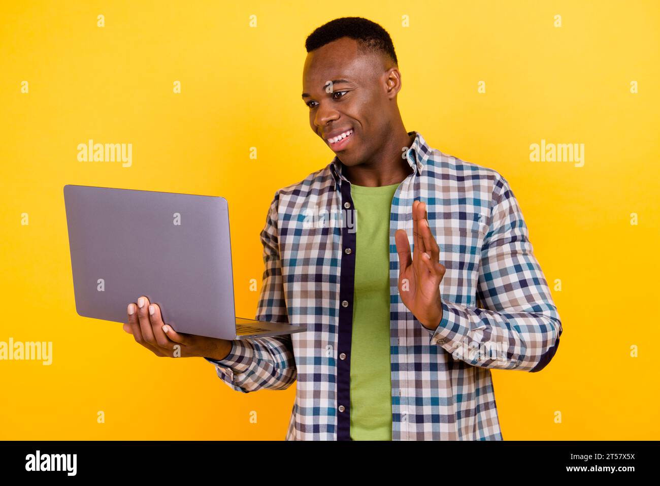 Photo of startuper guy wear plaid shirt waving palm watching computer ...