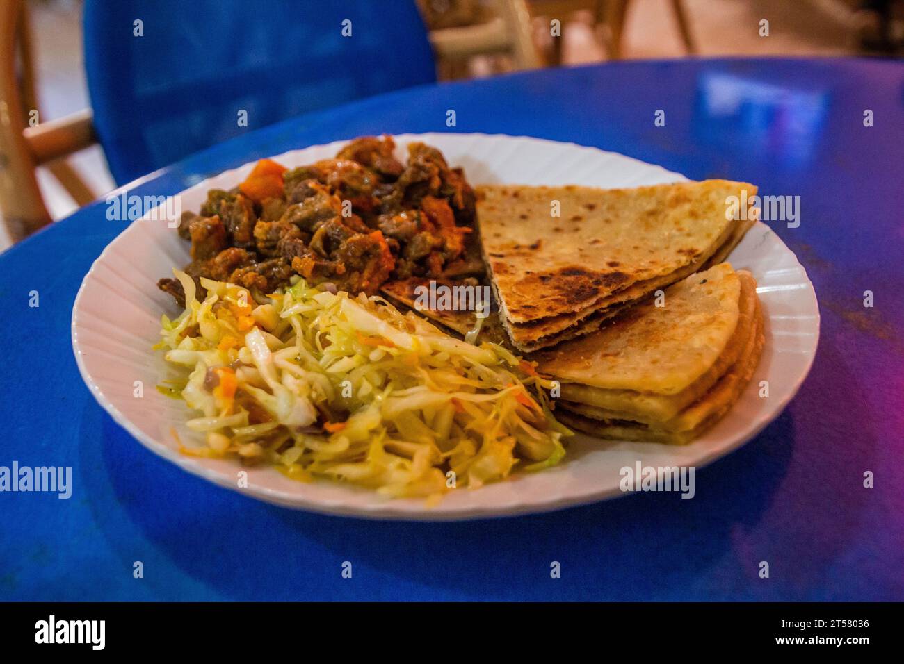 Meal in Kenya - beef stew with cabbage and chapati Stock Photo - Alamy