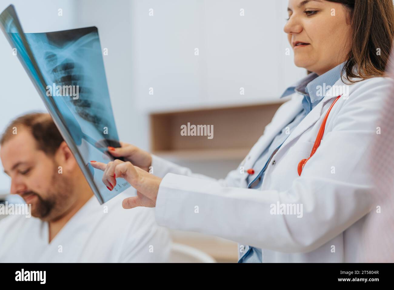 Experienced doctors carefully examining chest x-ray film for potential ...
